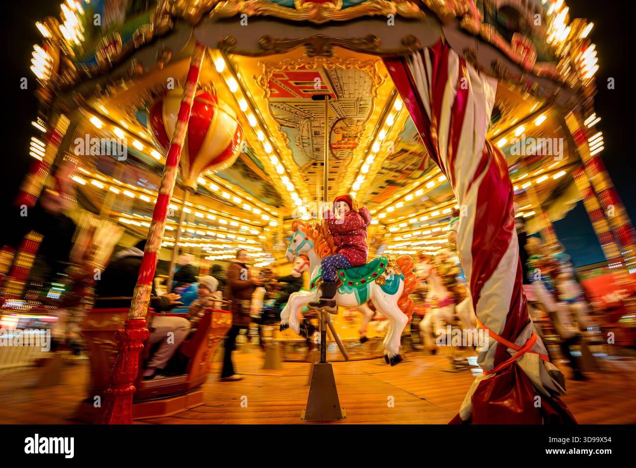 FILE - A child rides a merry-go-round at a Christmas fair in Bucharest ...