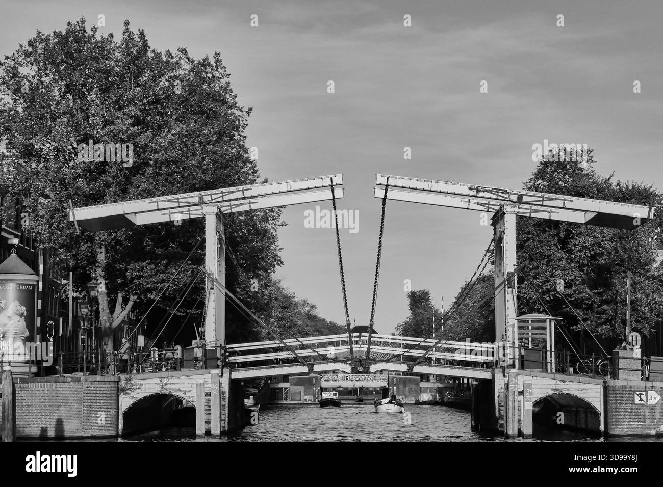 Historic Drawbridge Over Calm Canal With Boats And Trees In The Quiet ...