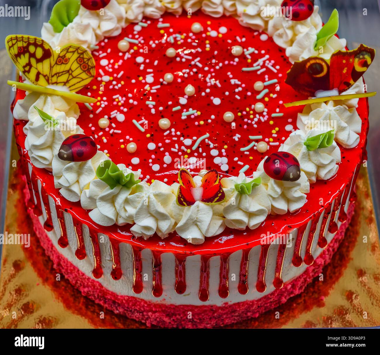 Red Velvet Drip Cake with Whipped Cream Rosettes and Colorful Sprinkles ...
