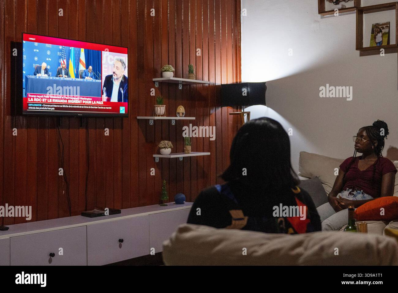 A family watches the live broadcast of the signing ceremony for the ...