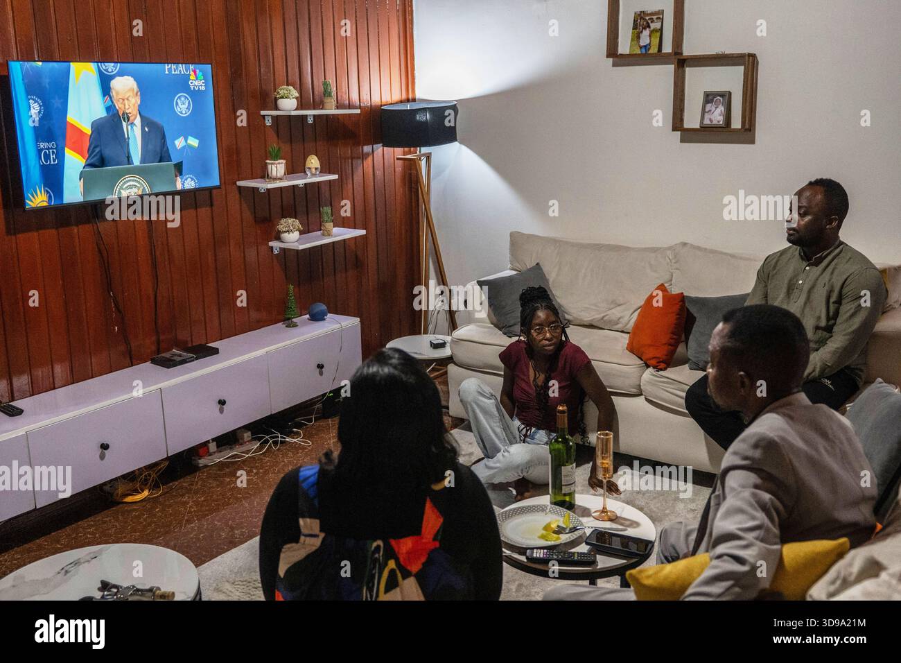 A family watches the live broadcast of the signing ceremony for the ...