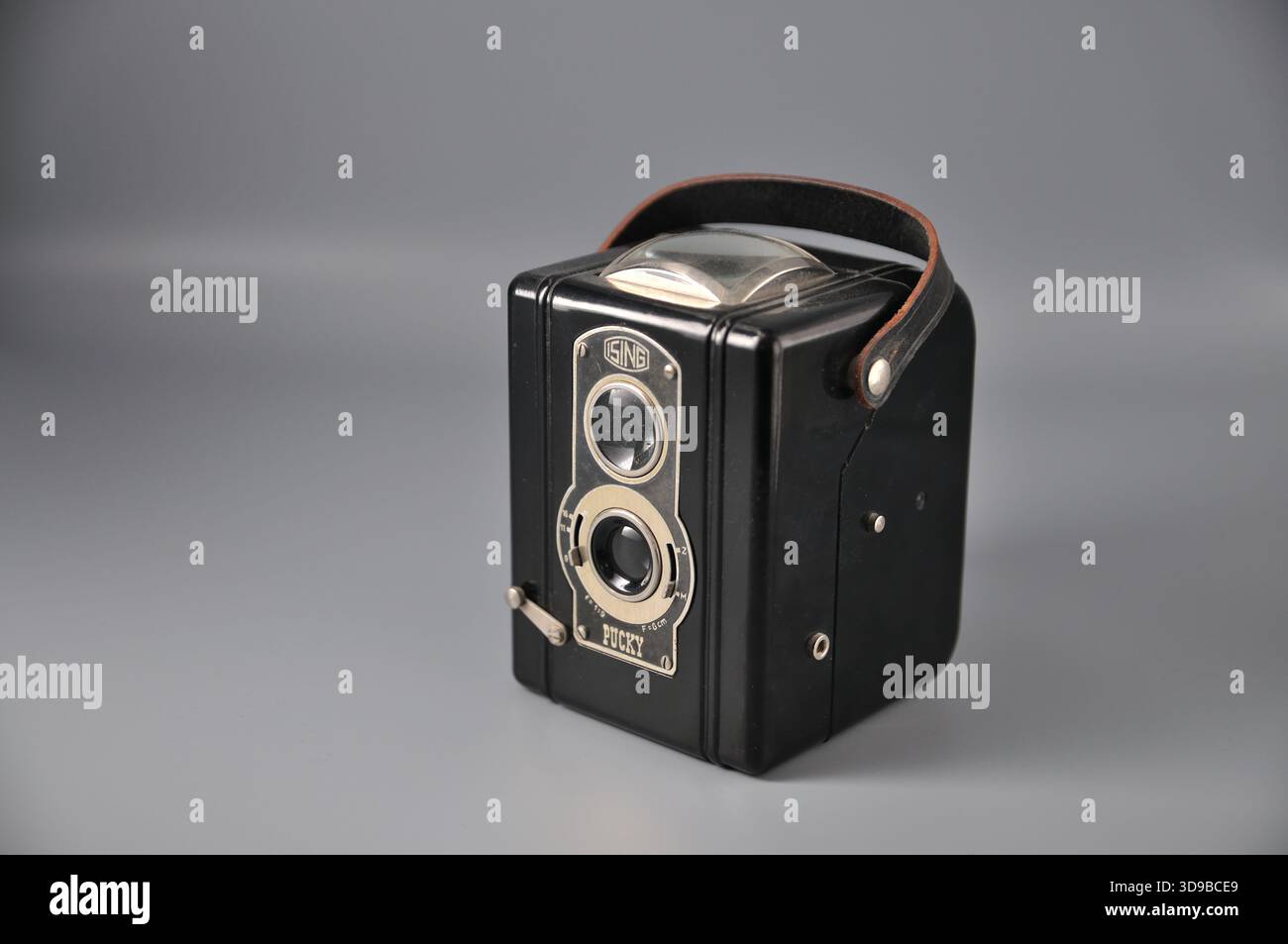 Old box-style film camera with top viewfinder and manual settings. A ...