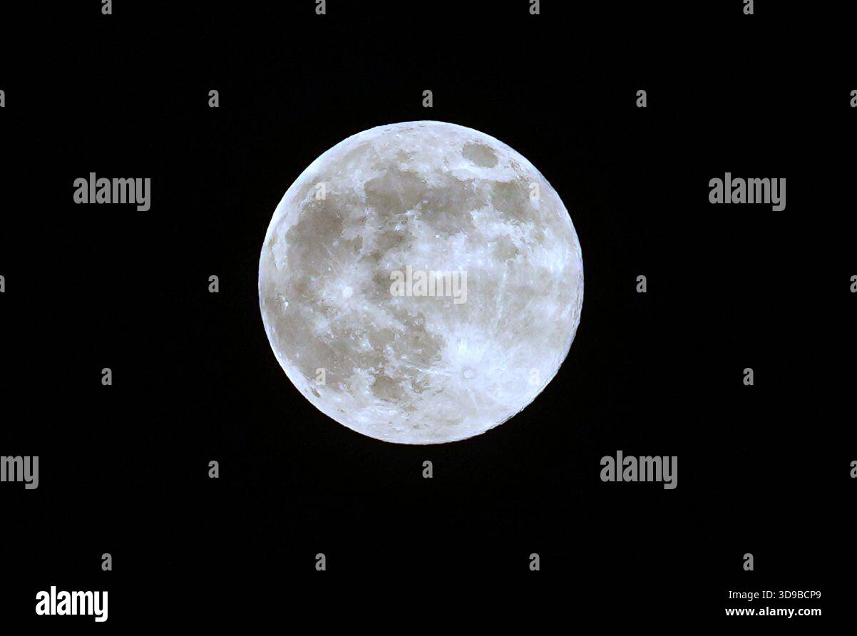 The moon rises over Philadelphia, Thursday, Dec. 4, 2025. (AP Photo ...