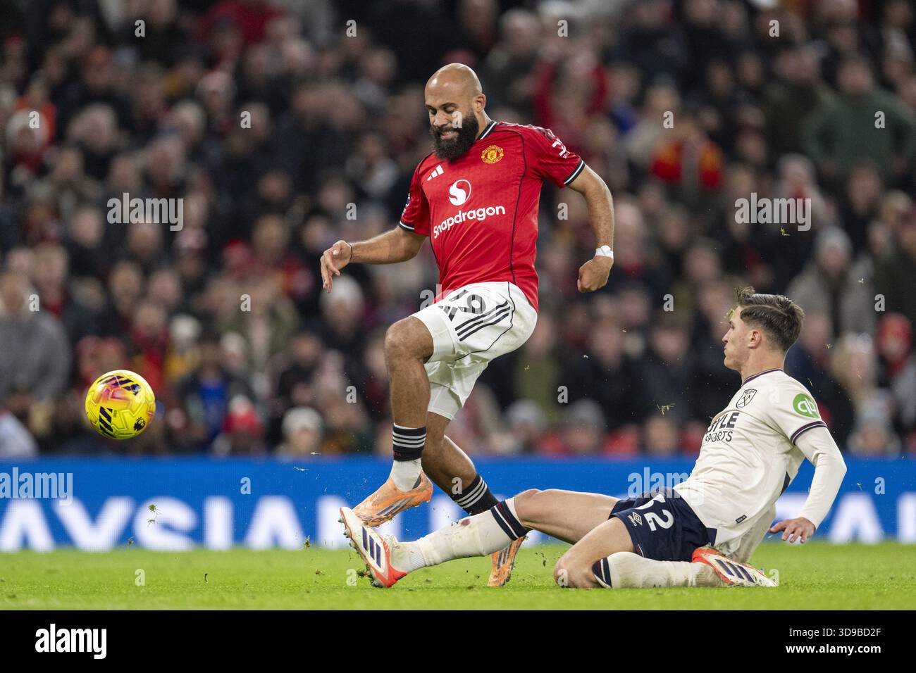 MANCHESTER, ENGLAND, DEC 04: Freddie Potts of West Ham and Bryan Mbeumo ...