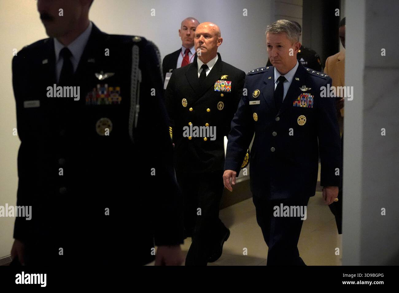 U.S. Navy Adm. Frank M. Bradley, center, accompanied by Gen. Dan Caine ...