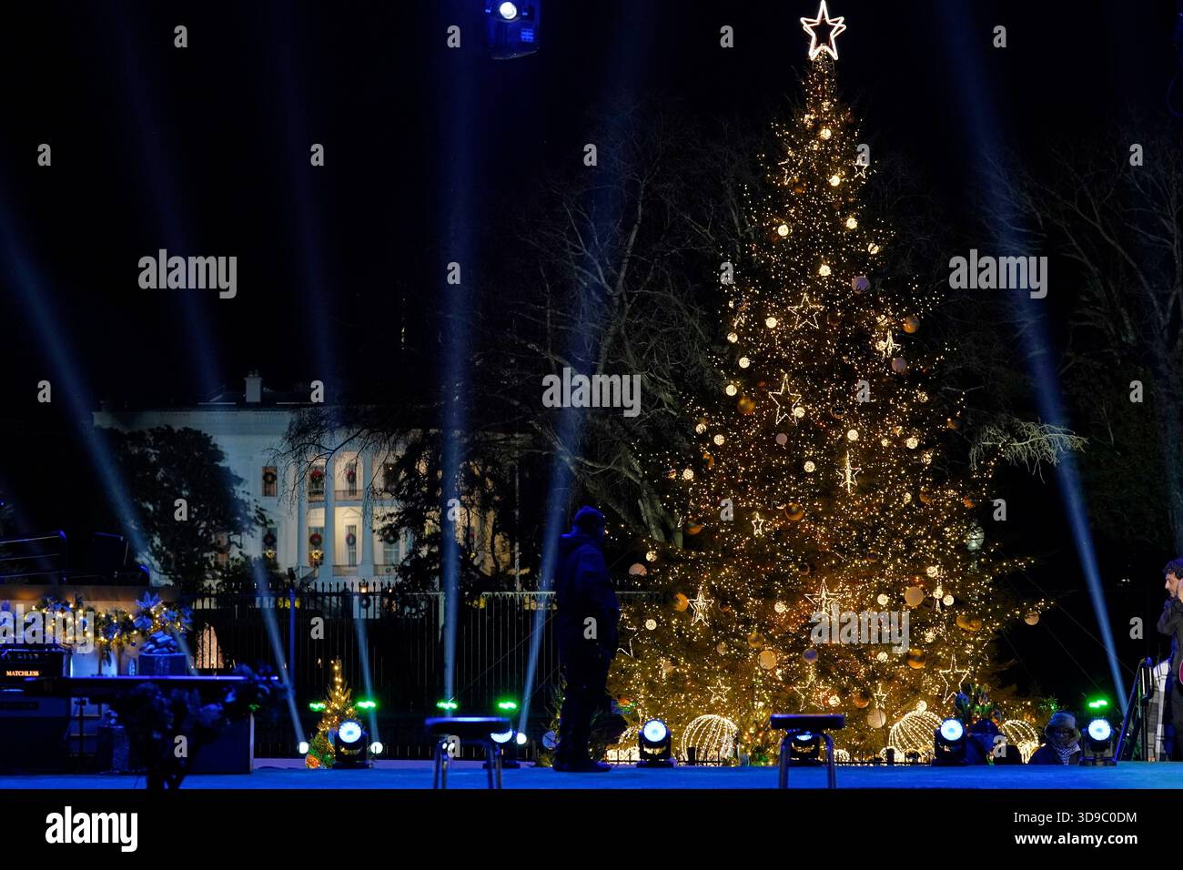 The National Christmas Tree is lit by the White House, at left, on the ...
