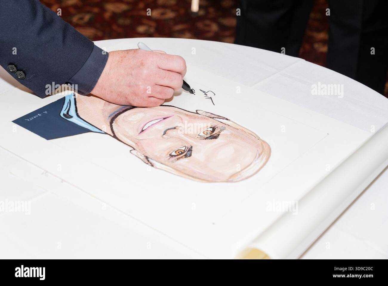 Scott Ellis signs portrait during unveiling of portrait of theater ...