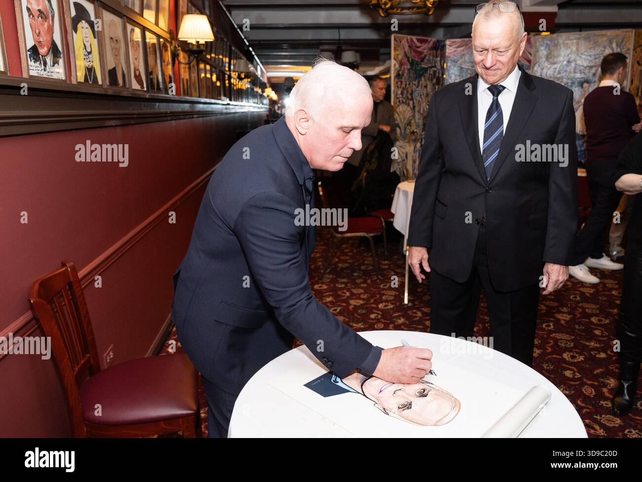 Scott Ellis signs portrait during unveiling of portrait of theater ...
