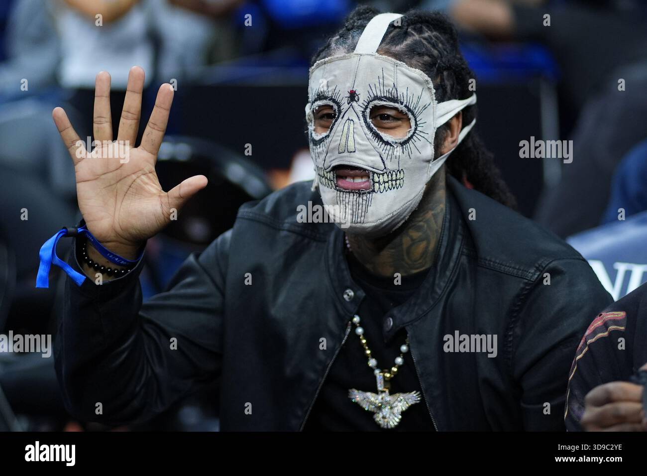 Rapper Skrilla reacts during the first half of an NBA basketball game ...