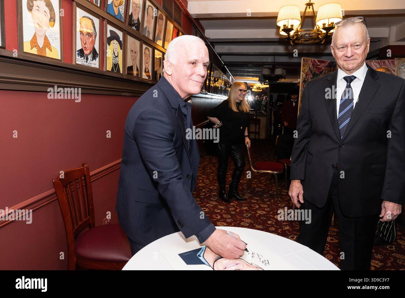 Scott Ellis signs portrait during unveiling of portrait of theater ...