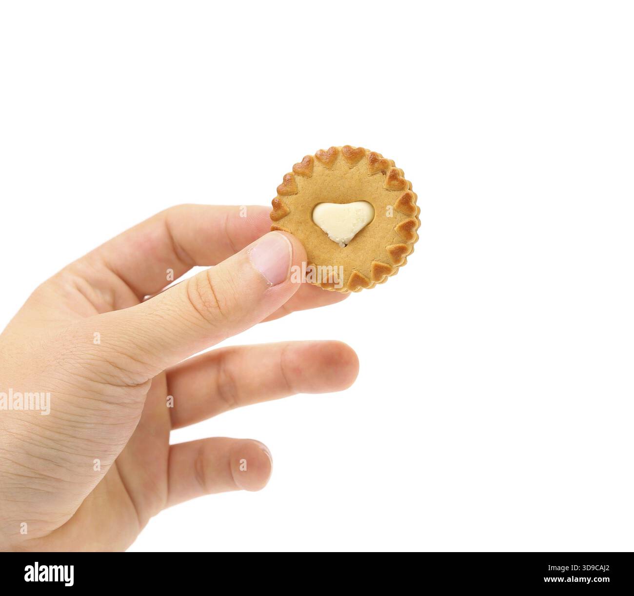 Hand holds biscuits with white heart. Cookie biscuits with filling ...