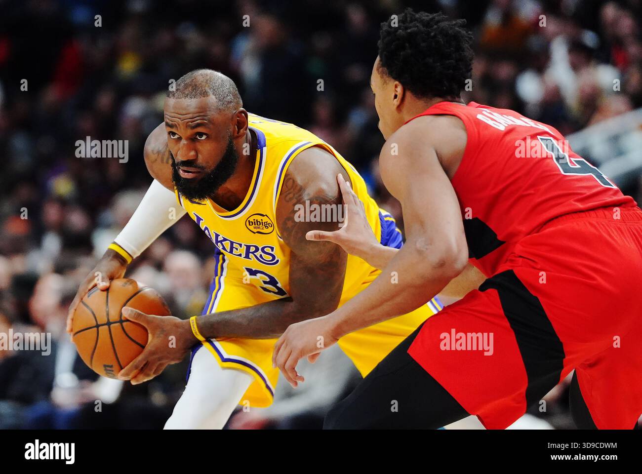 Los Angeles Lakers' LeBron James (23) is guarded by Toronto Raptors' Scottie Barnes (4) during ...