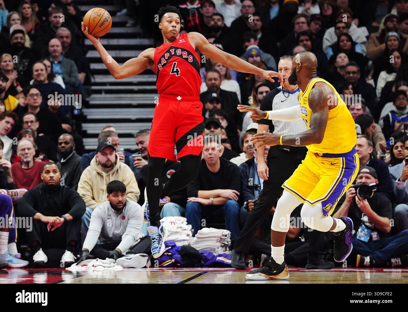 Toronto Raptors' Scottie Barnes (4) passes over Los Angeles Lakers' LeBron James (23) during ...