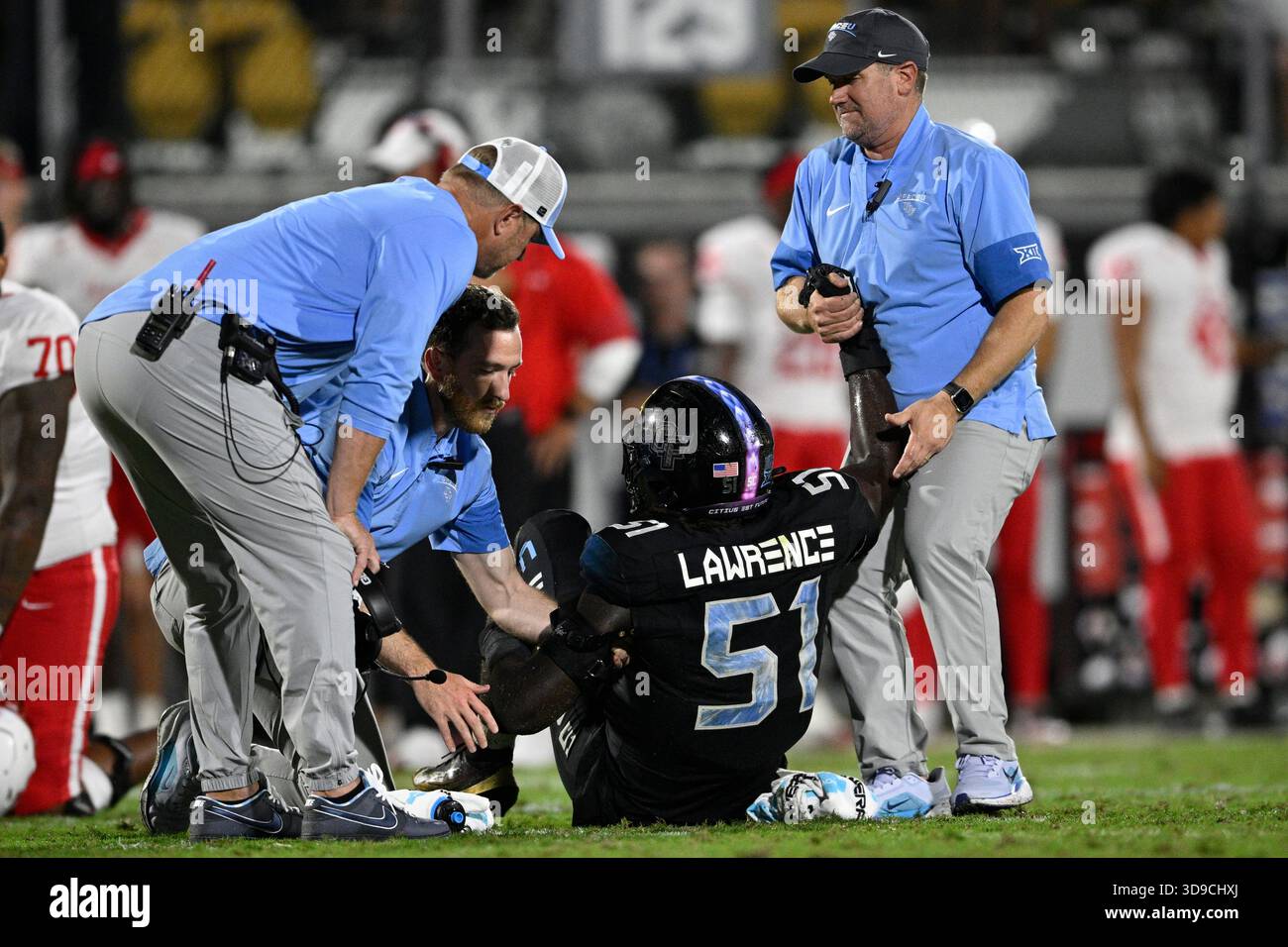 Central Florida defensive end Malachi Lawrence (51) is helped by ...