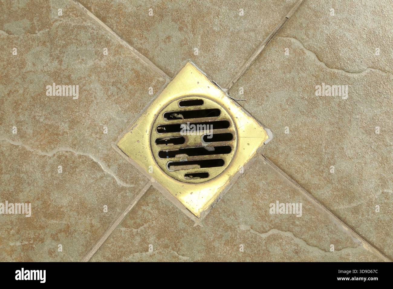 Sewer grate drain water on the tile floor in bathroom Stock Photo - Alamy