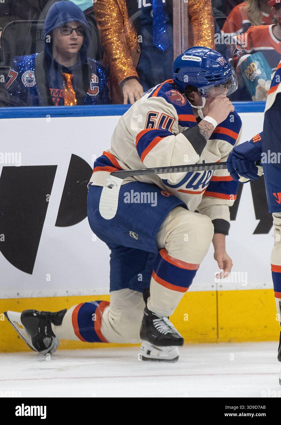 Edmonton Oilers' Connor Clattenburg (64) reacts after taking a stick to ...