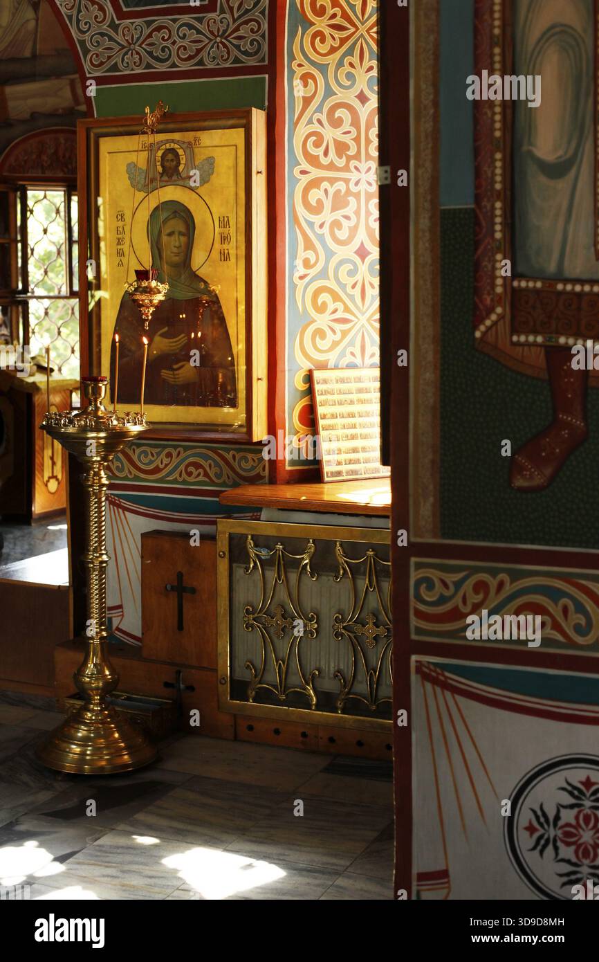 Interior of russian orthodox church. Candles under the ancient icon ...