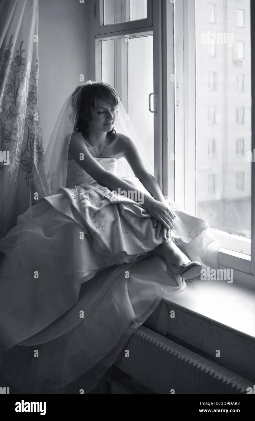The beautiful thoughtful bride in an interior Stock Photo - Alamy