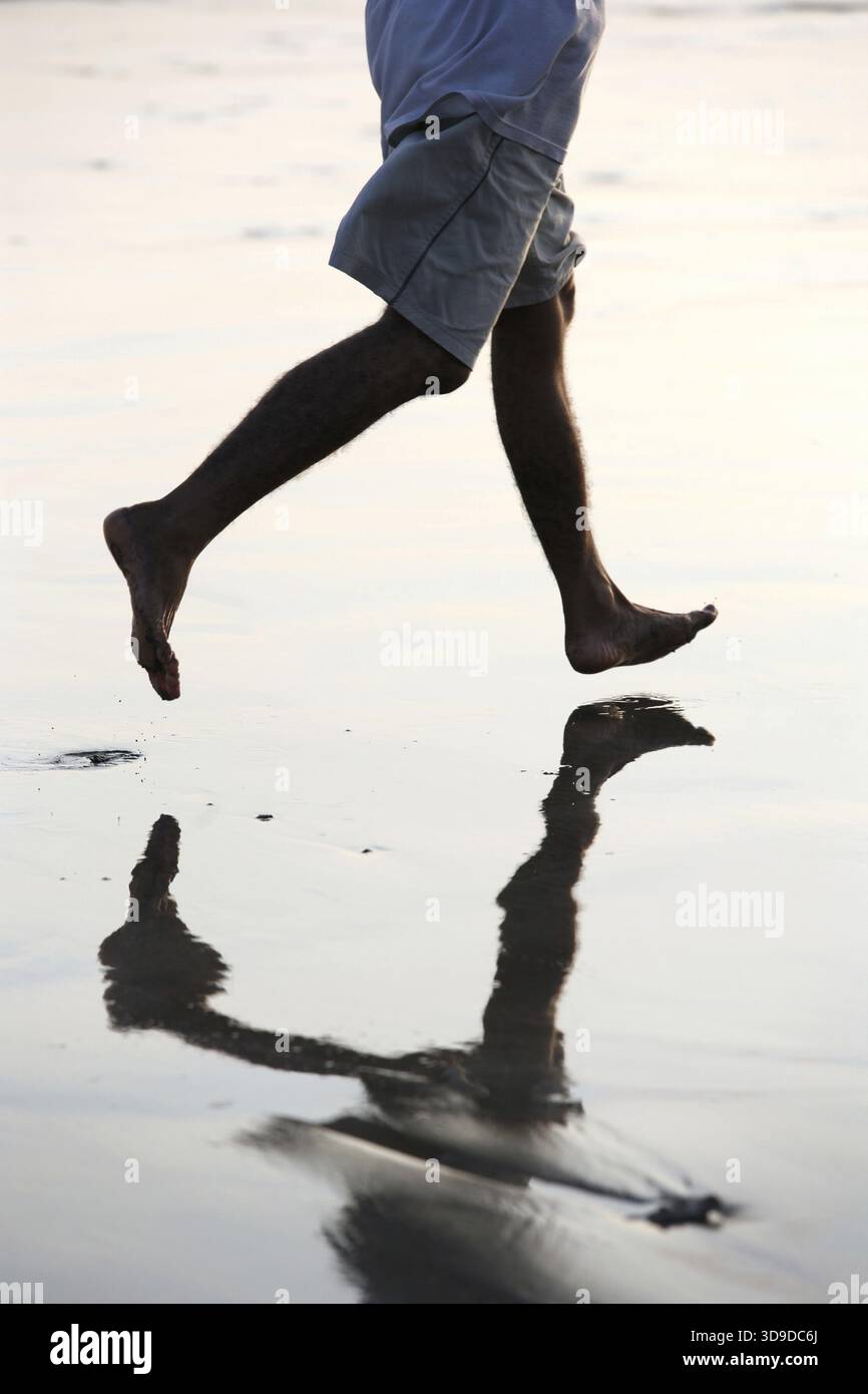 Man running on beach feet hi-res stock photography and images - Alamy