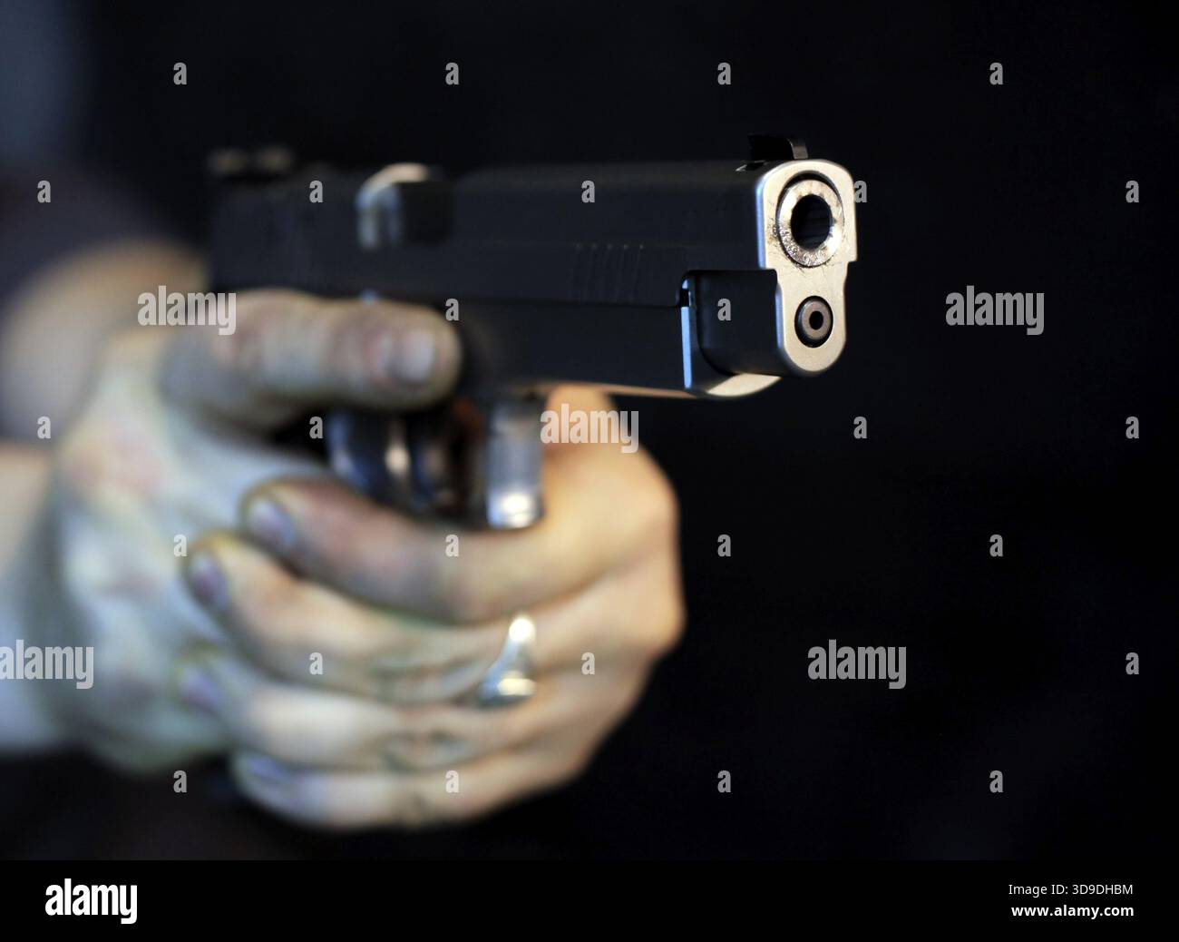 Man pointing a gun looking at the camera Stock Photo - Alamy