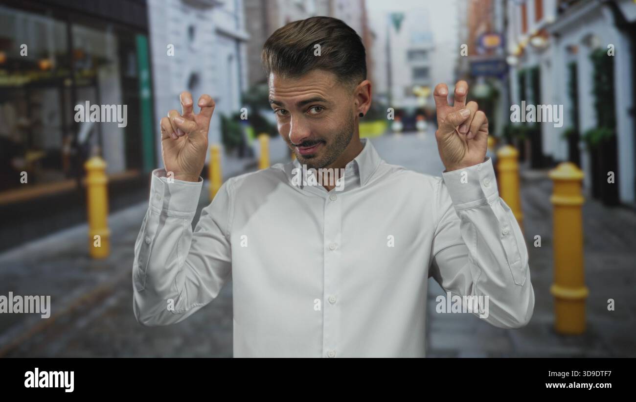 Hispanic man wearing white shirt shows peace sign with both hands on ...