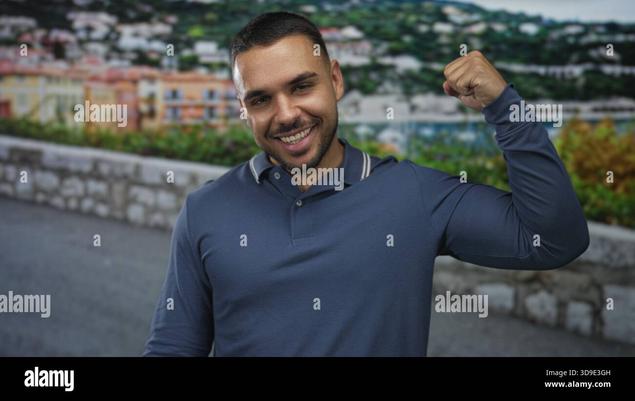 Man flexes bicep on seaside hi-res stock photography and images - Alamy