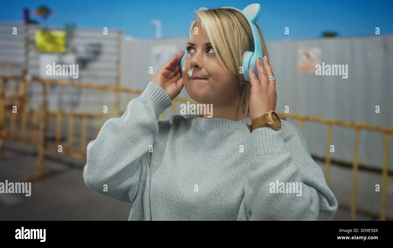 Woman building adjusts headphones hi-res stock photography and images ...