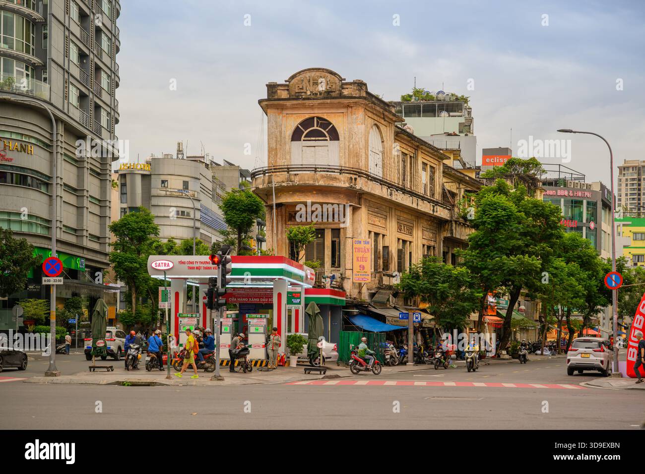 Old and new buildings behind a modern petrol station at Ho Chi Minh ...