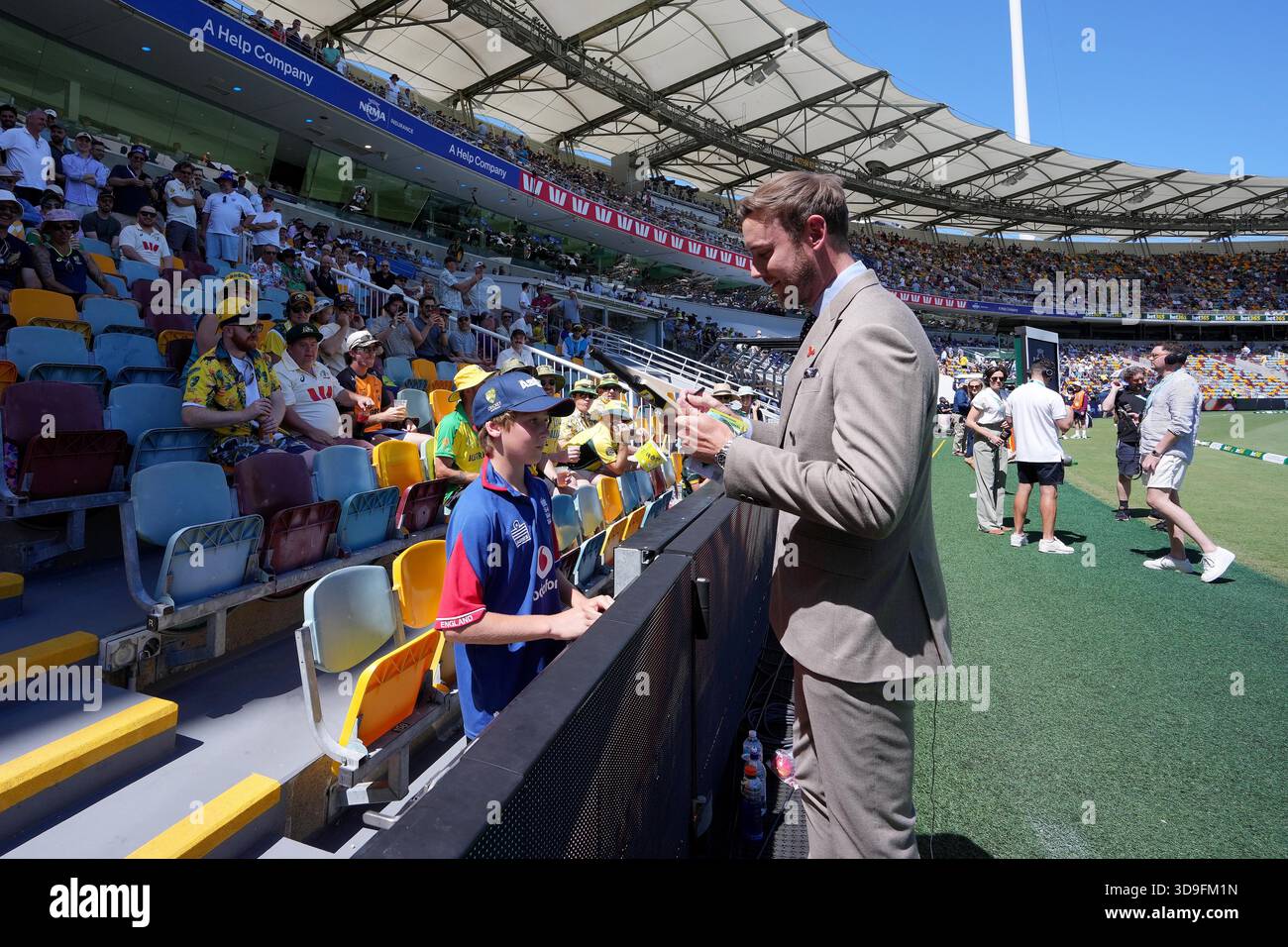 Former England player Stuart Broad (right) signs an autograph for a fan ...