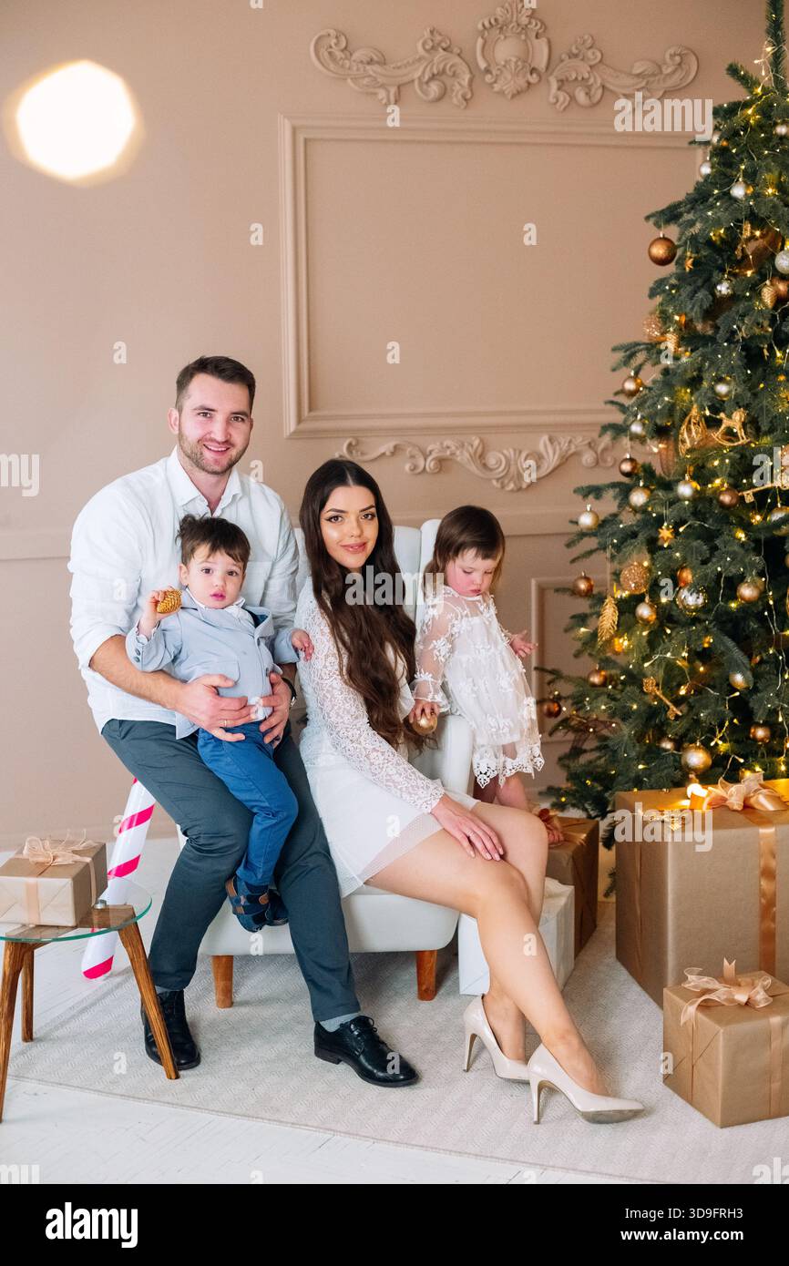 A happy family poses together in a stylish room with a beautifully ...