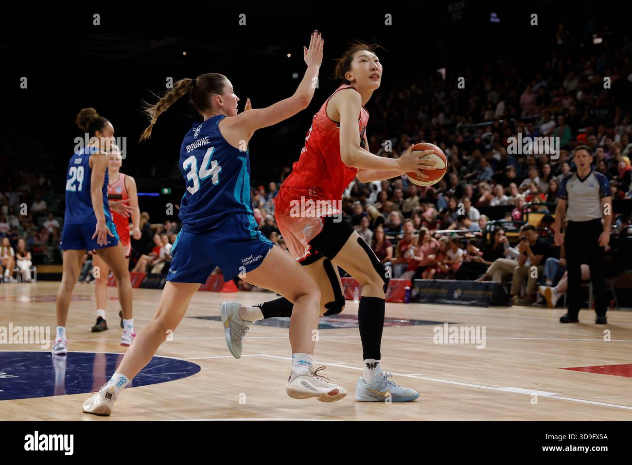 Han Xu of the Lynx drives past Isabelle Bourne of the Flyers during the ...