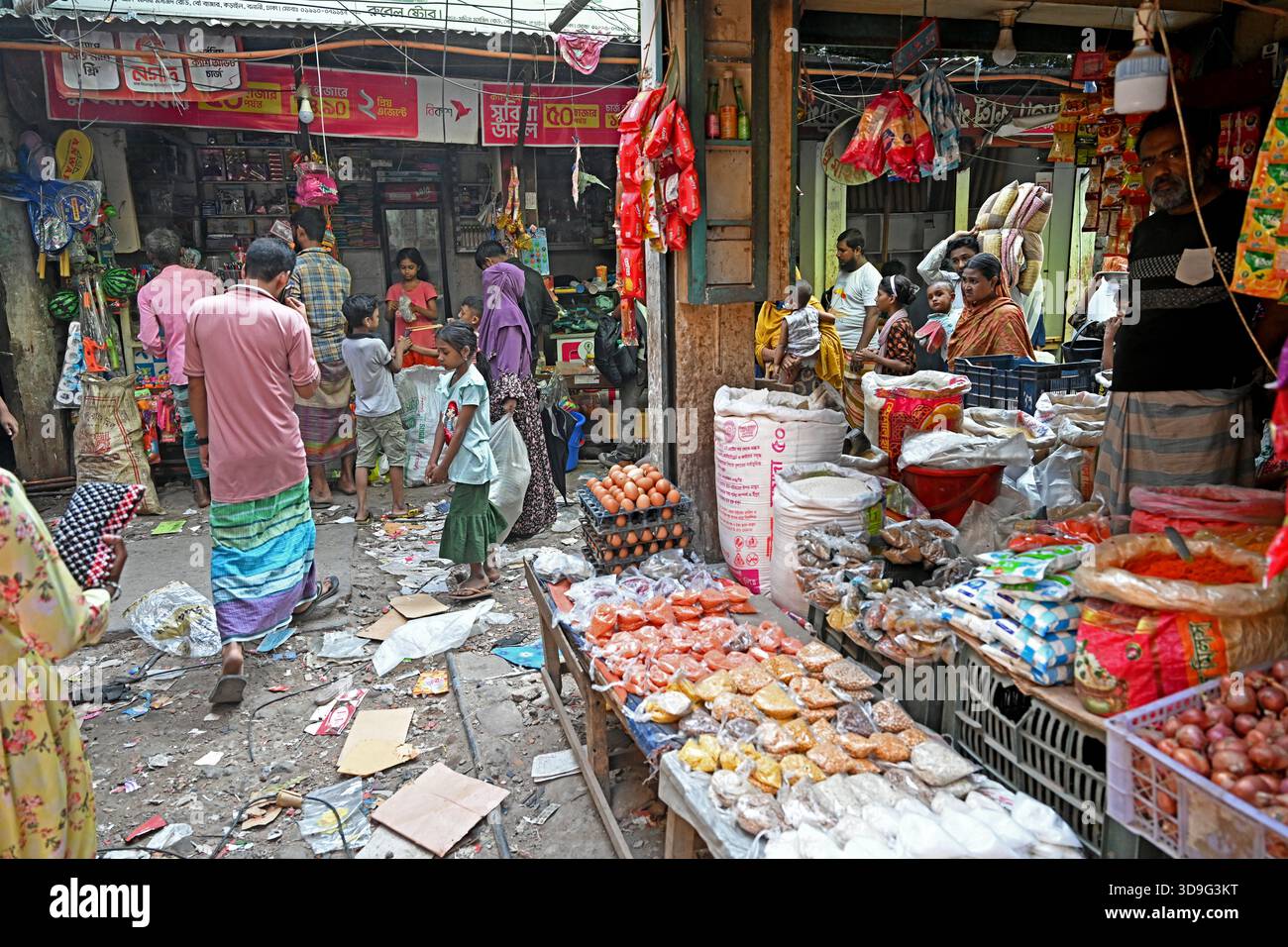 Slum dwellers are walking in the Korail slum in Dhaka, Bangladesh, on ...