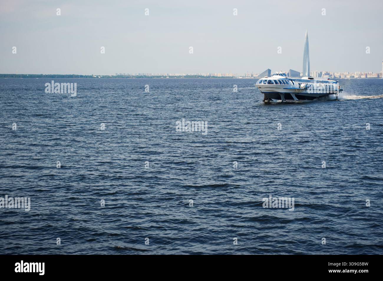 Modern hydrofoil boat rapidly moving on the water, leaving a wake, with ...