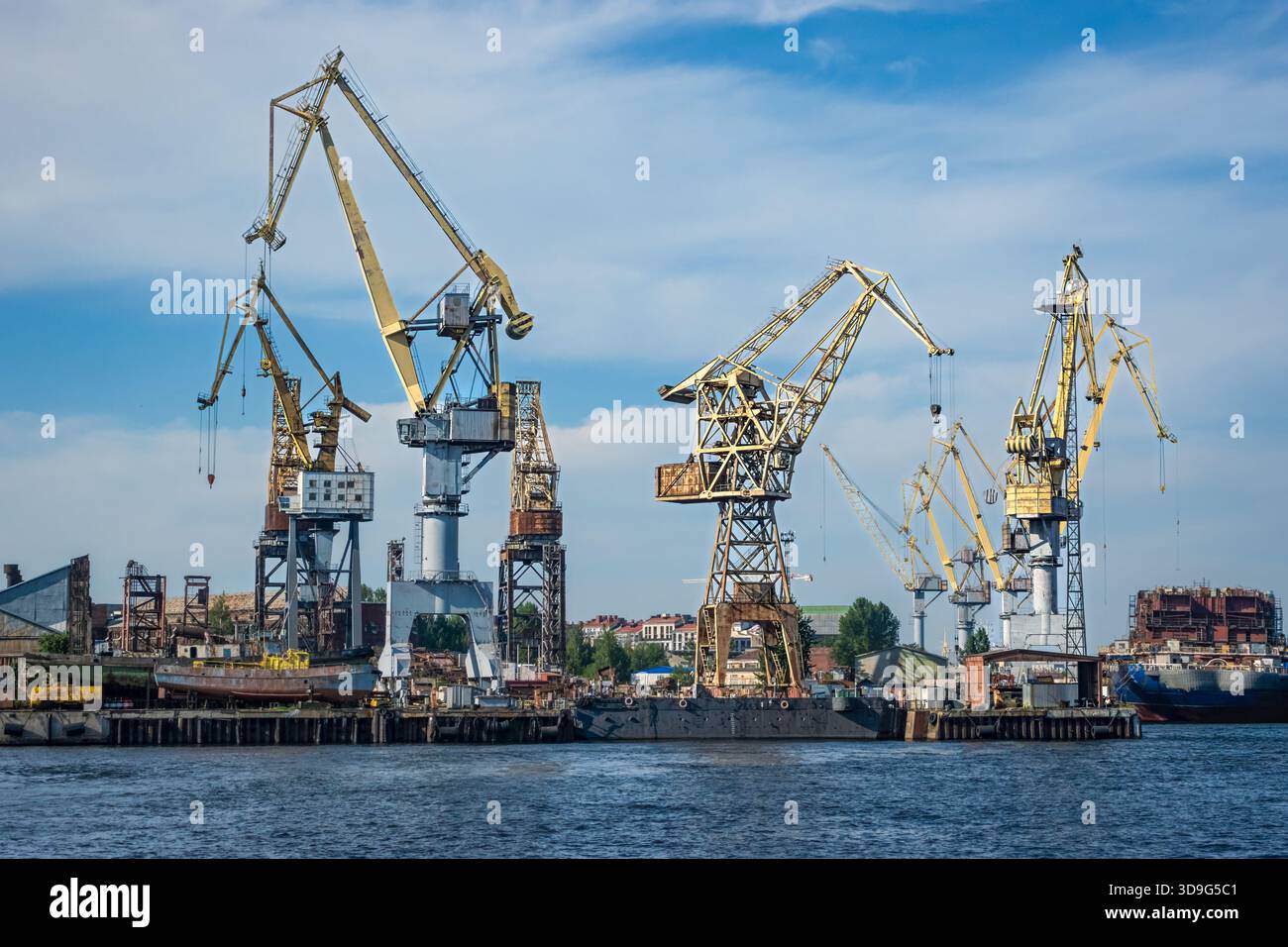 Industrial port showing numerous large heavy lift cranes operating at a ...