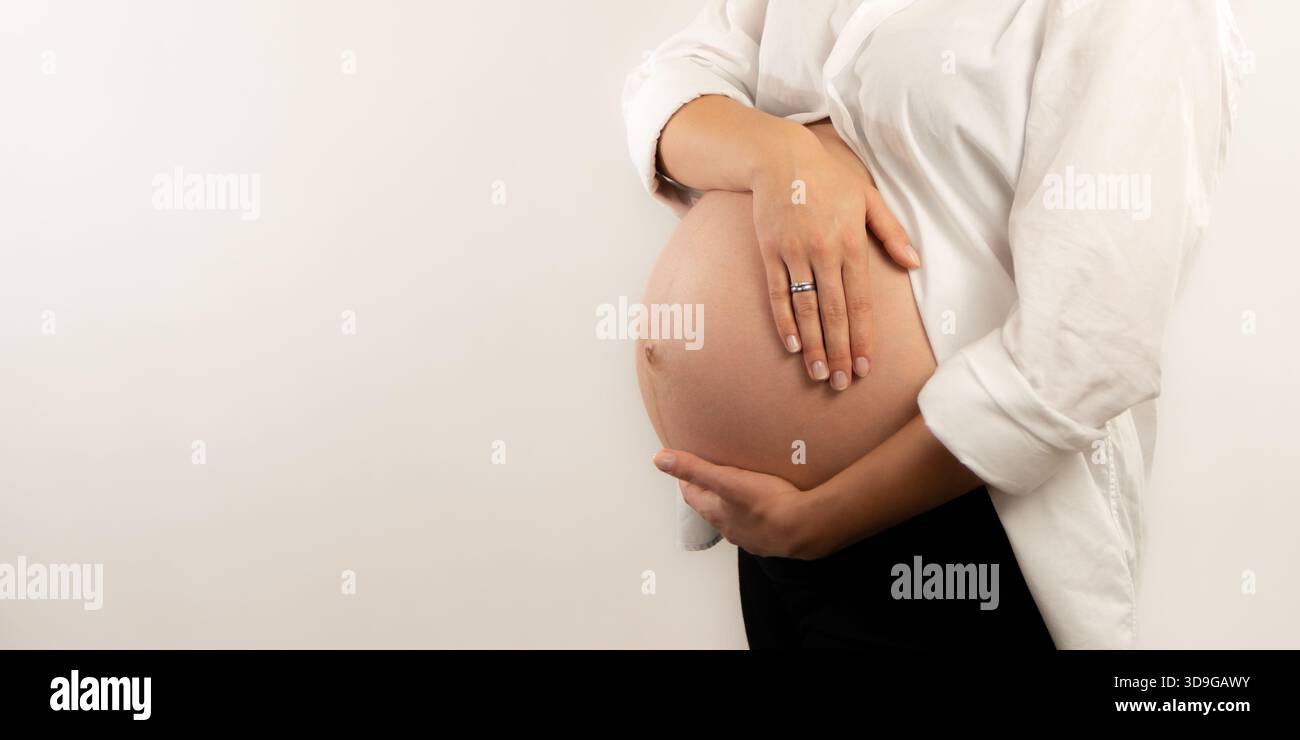 Woman In White Shirt With Hand On Pregnancy Belly. Childbirth School ...