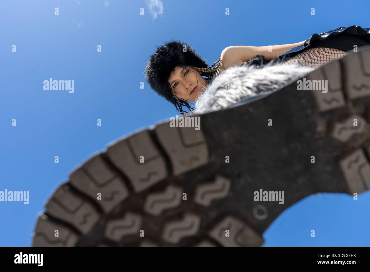 Woman wearing a fur hat and combat boot, stomping down with an ...