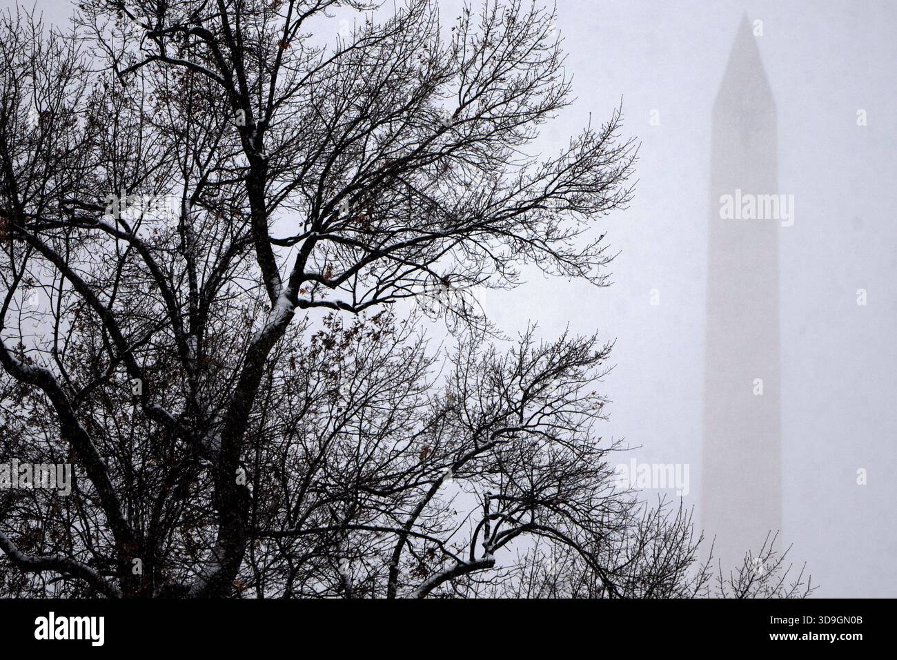 The Washington Monument is seen amid falling snow during the first ...