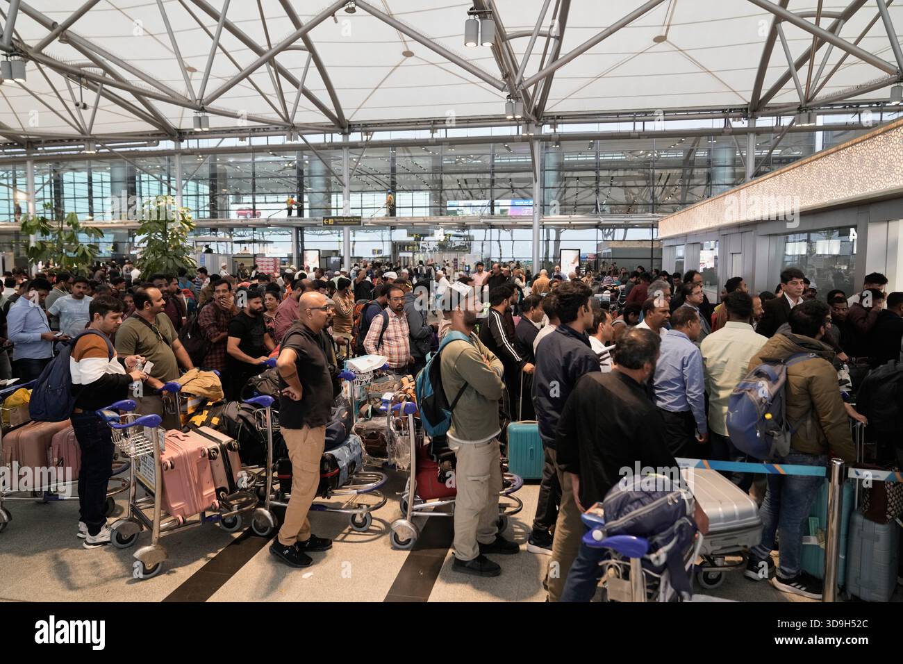 Passengers line up at an IndiGo Airlines ticket counter at the Rajiv ...