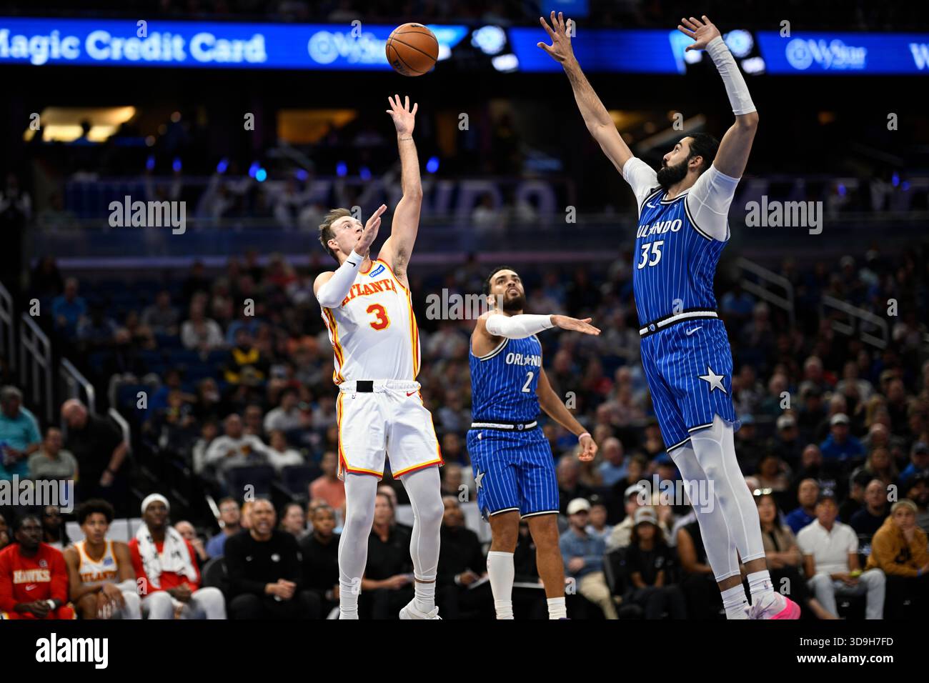 Atlanta Hawks guard Luke Kennard (3) shoots as Orlando Magic guard Tyus ...