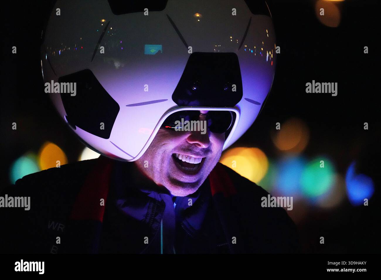 Gregg Wilson, of Dallas, wears a soccer themed helmet during a watch ...