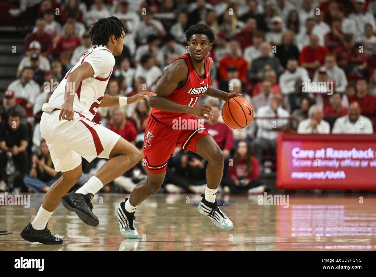 Louisville guard Kobe Rodgers (11) runs a play against Arkansas during ...