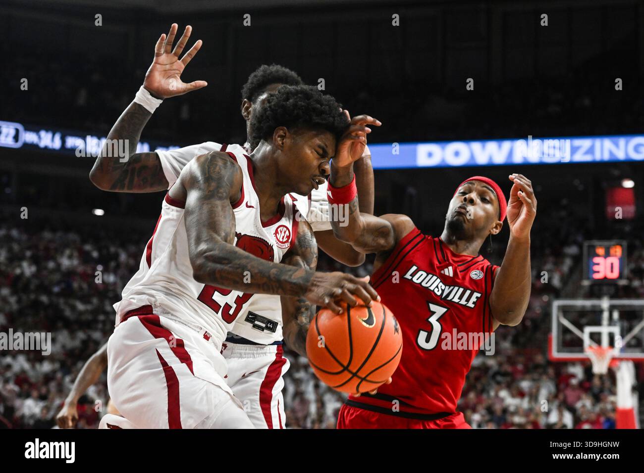 Arkansas forward Nick Pringle (23) and Louisville guard Ryan Conwell (3 ...