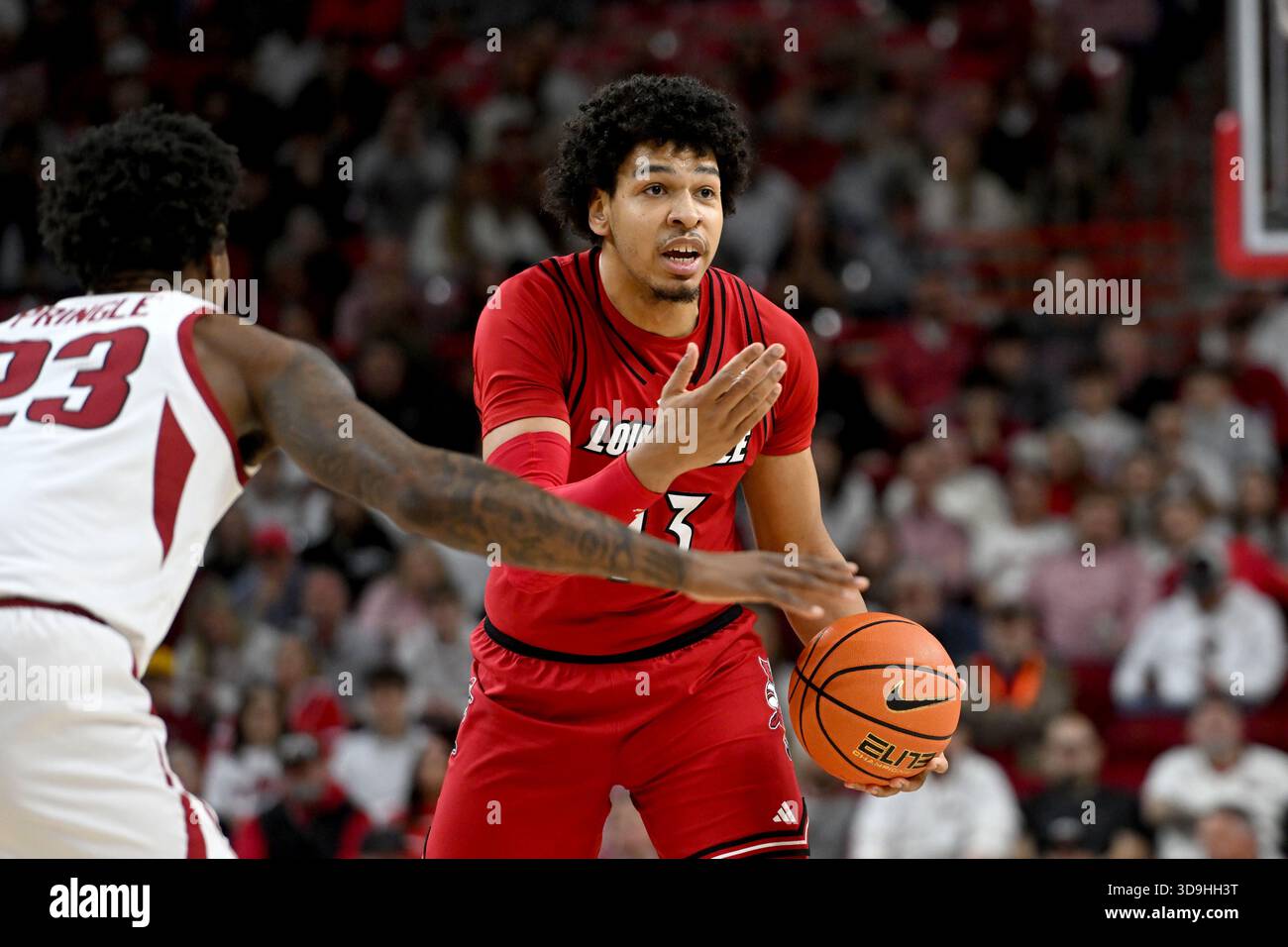 Louisville forward Sananda Fru (13) runs a play against Arkansas during ...