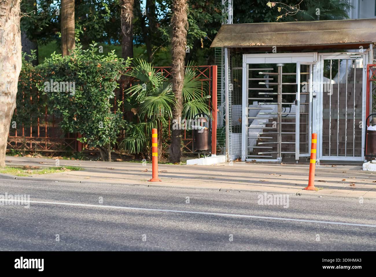 Frontal view of a barred gate with stairs, surrounded by tropical ...