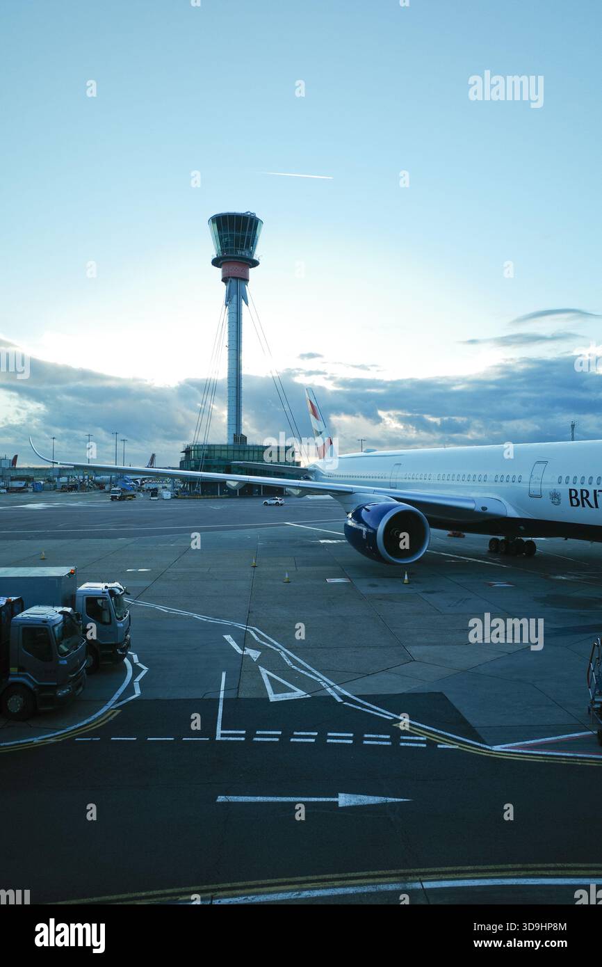 A view of the tarmac and air traffic control tower at Heathrow Airport ...
