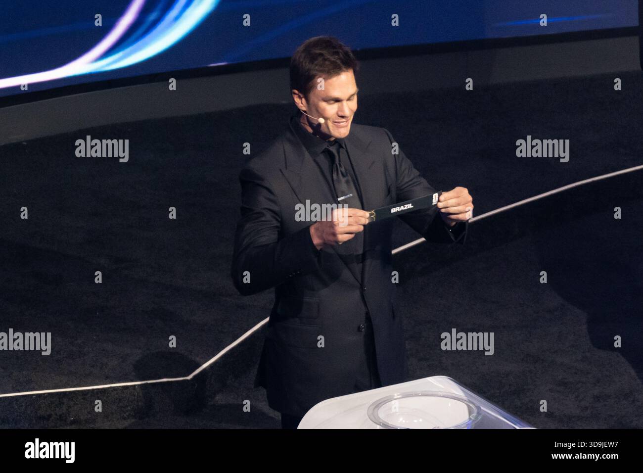 Tom Brady assists during the 2026 FIFA World Cup draw at the John F ...