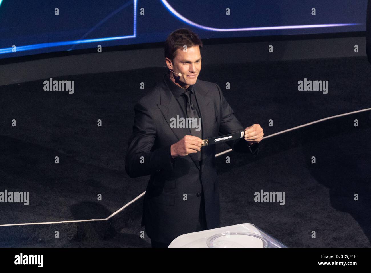Tom Brady assists during the 2026 FIFA World Cup draw at the John F ...