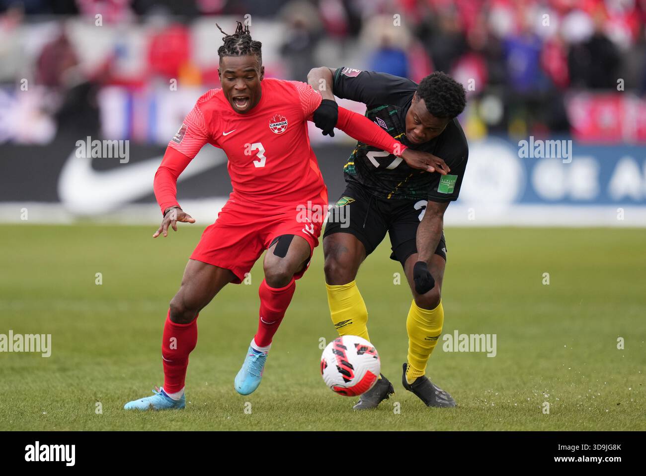 Canada's Sam Adekugbe and Jamaica's Javain Brown battle for ther ball ...