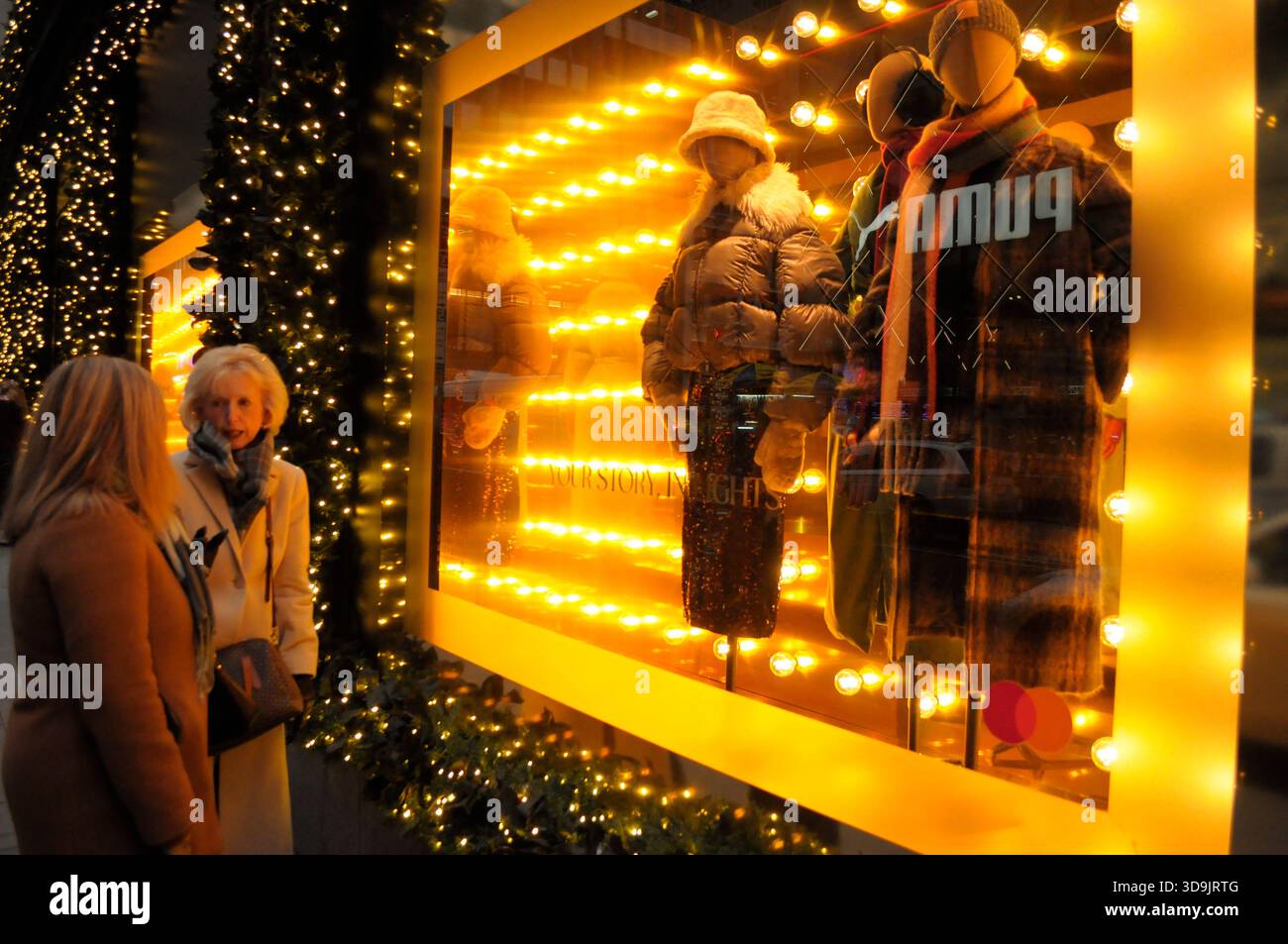 People view window displays at the Saks Fifth Avenue store on Fifth ...