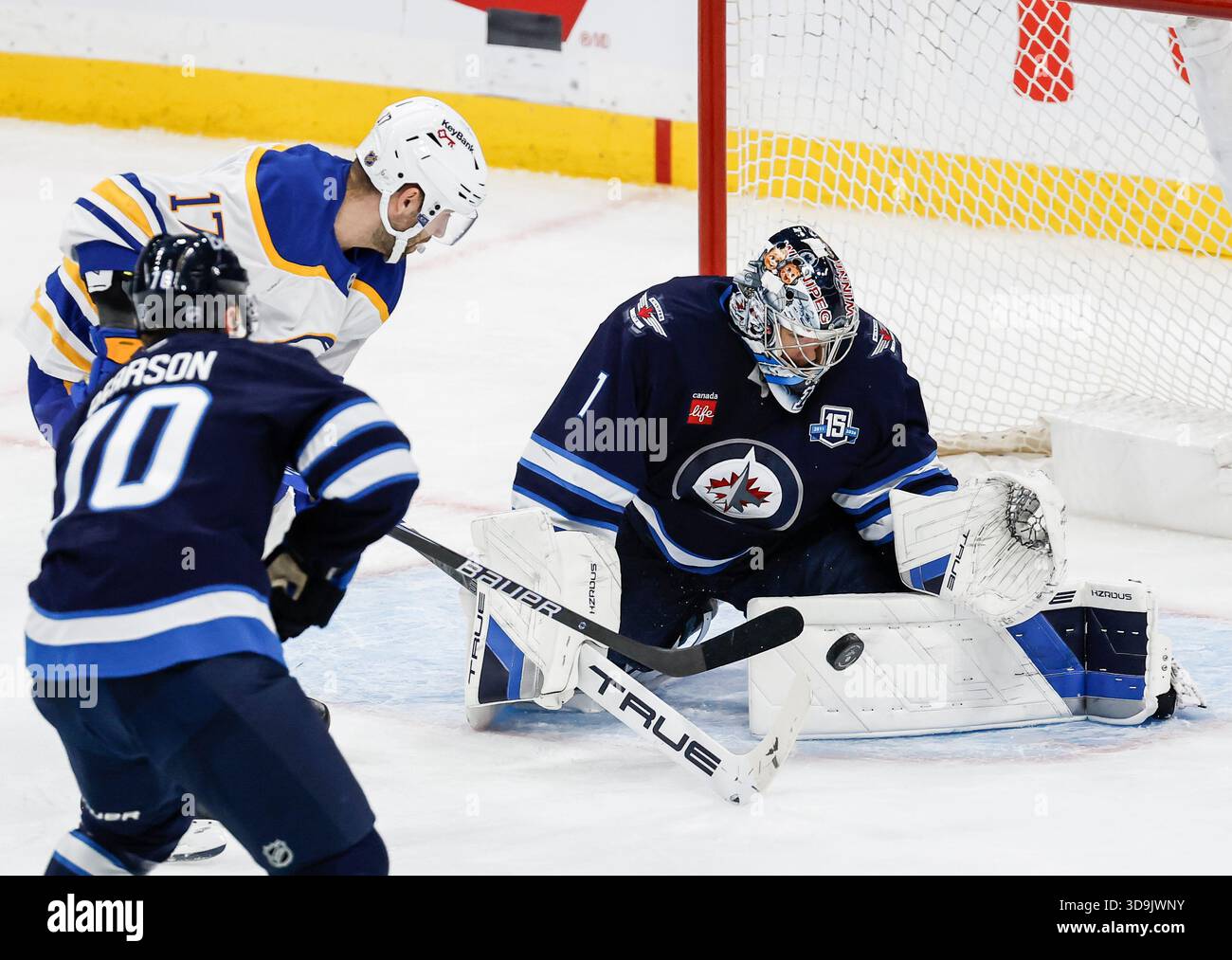 Winnipeg Jets goaltender Eric Comrie (1) saves the shot by Buffalo ...
